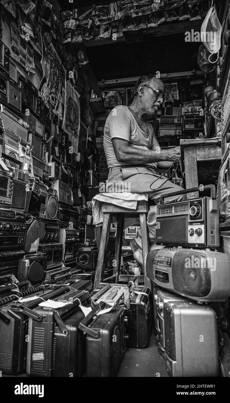 Grayscale shot of an old mechanic repairing a radio in his shop Stock ...