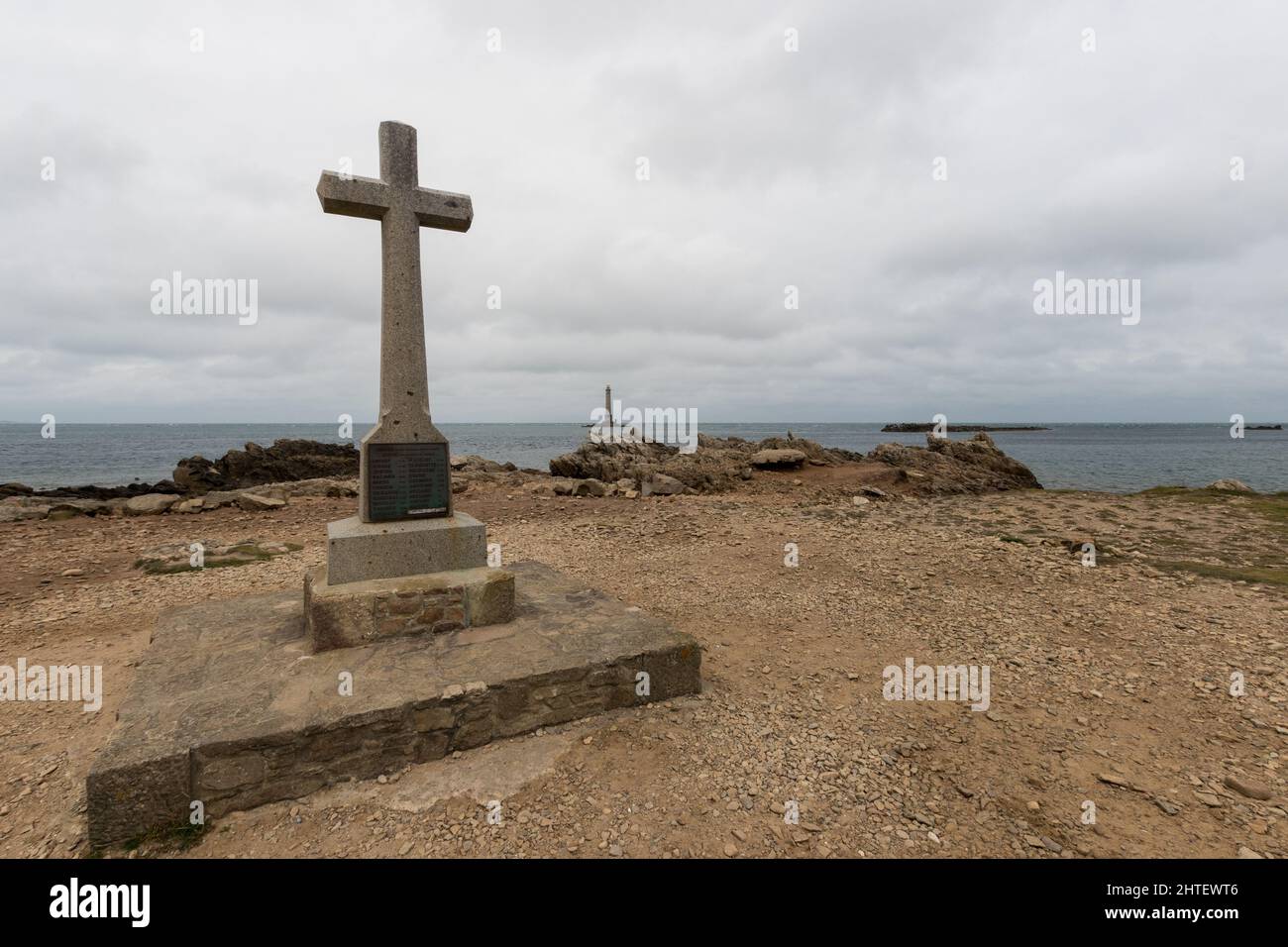 Cross at the Normandy seaside with a lighthouse in the background Stock ...
