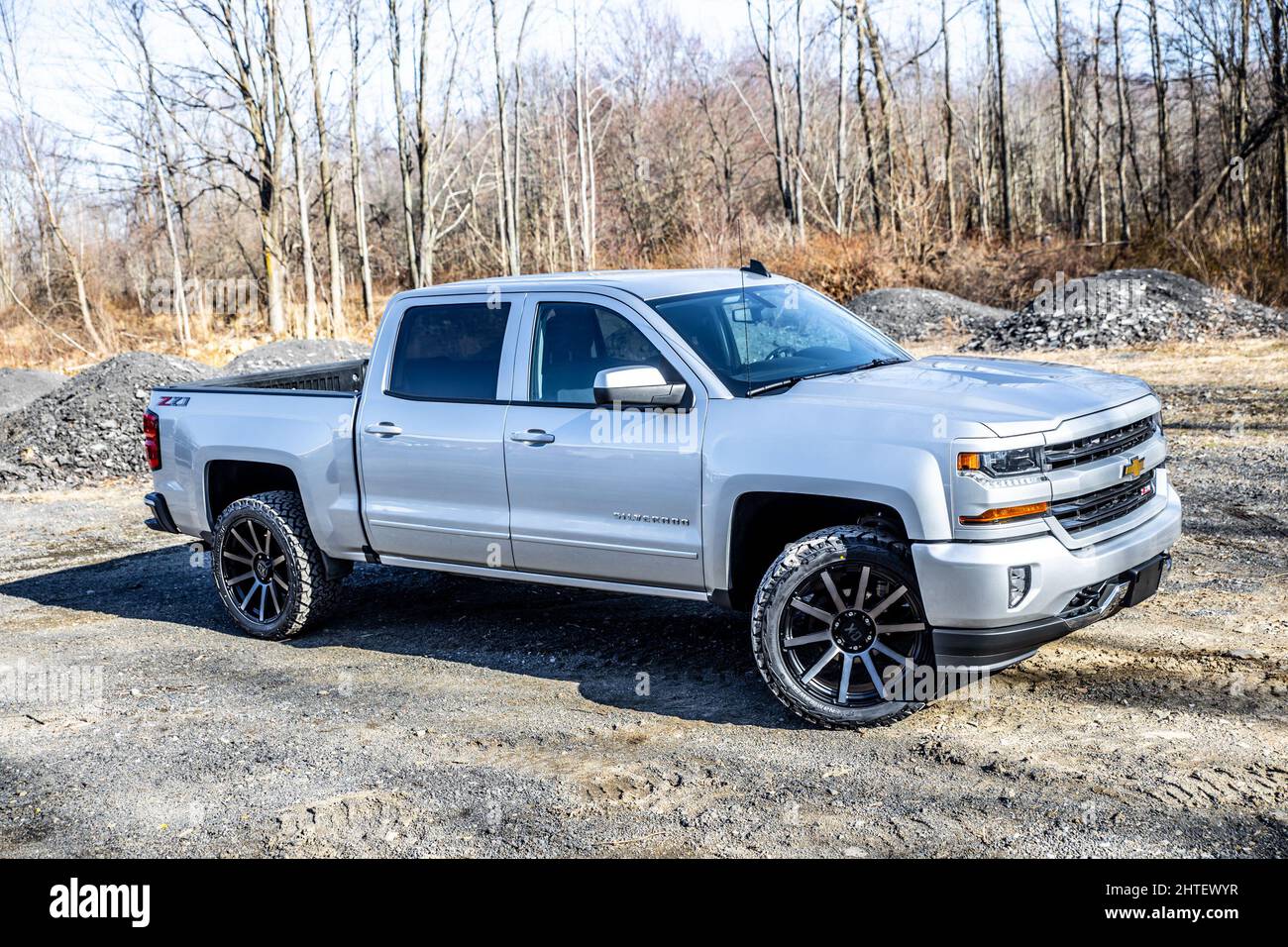 Chevrolet silverado 1500 parked on a dirt road in the background of ...