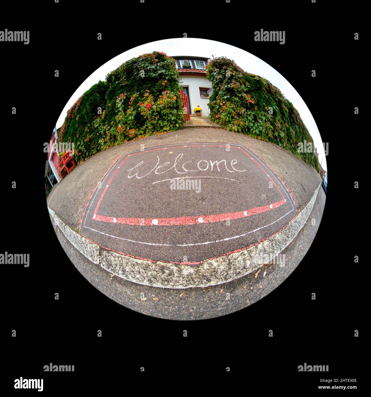 Fish-eye distortion shot of a Handmade welcome sign on a pavement in ...