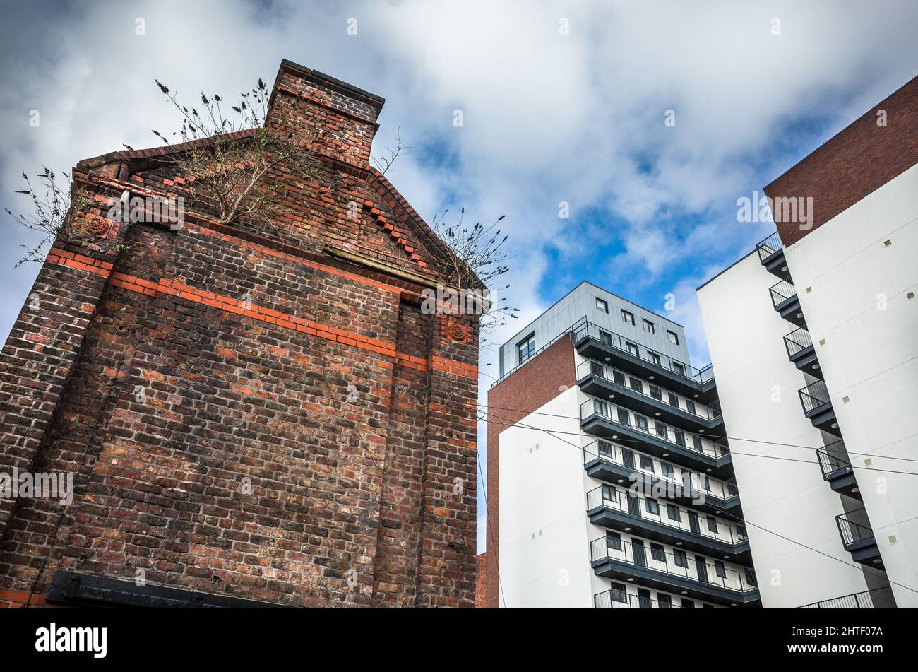 Contrasting modern high rise aprtments against a brick derelict ...