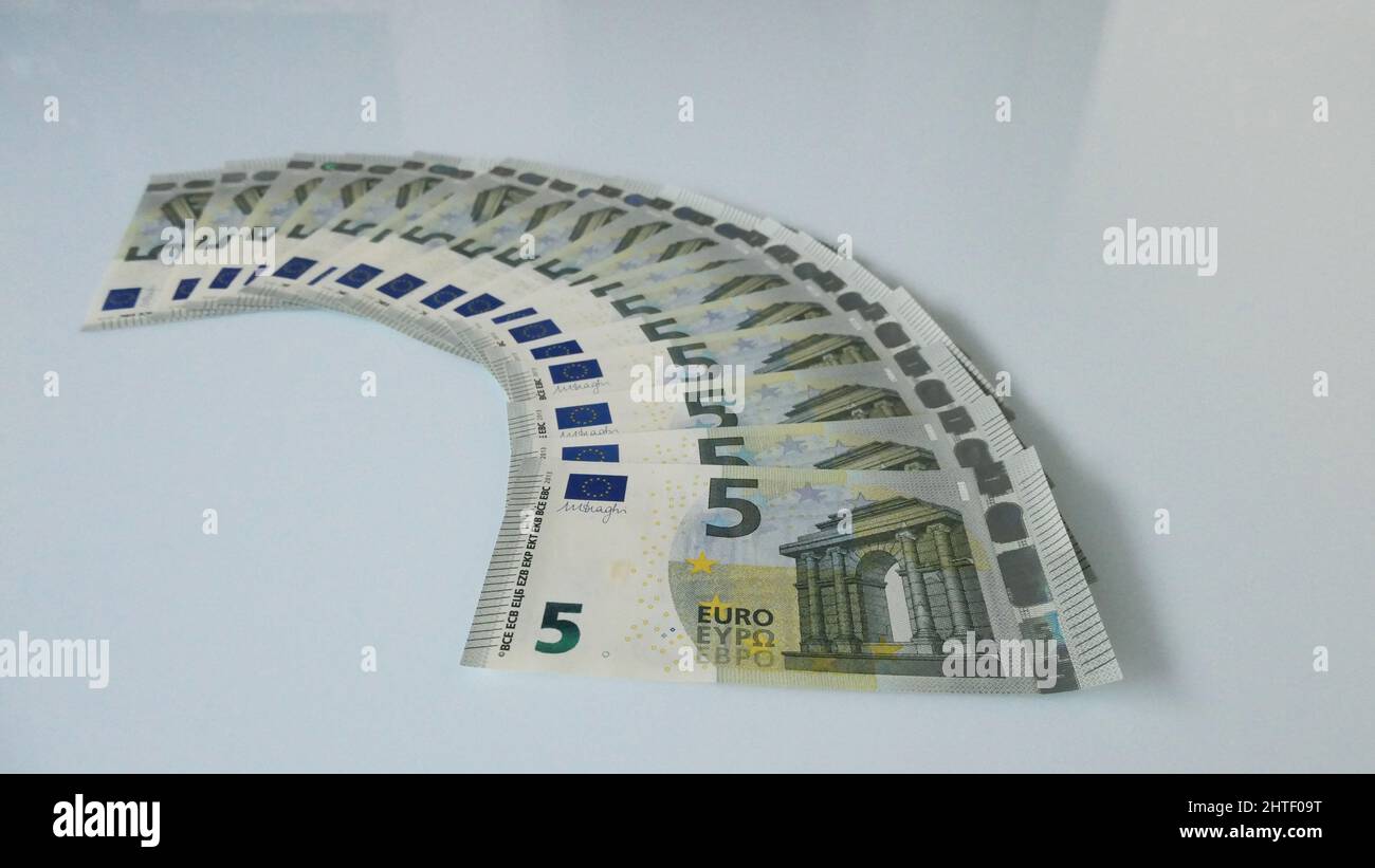 curve of lots of five euro bills isolated Stock Photo - Alamy