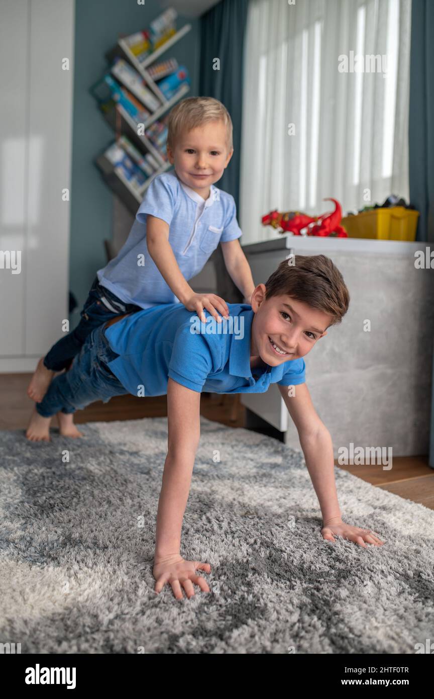 Joyous kid working out with his little brother Stock Photo - Alamy