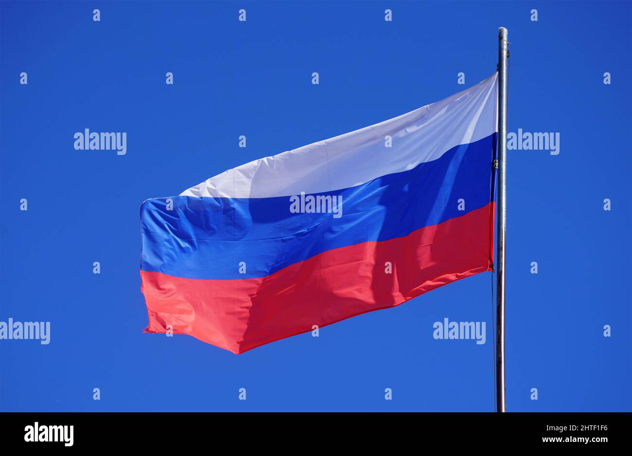 Russian flag against a blue sky Stock Photo - Alamy