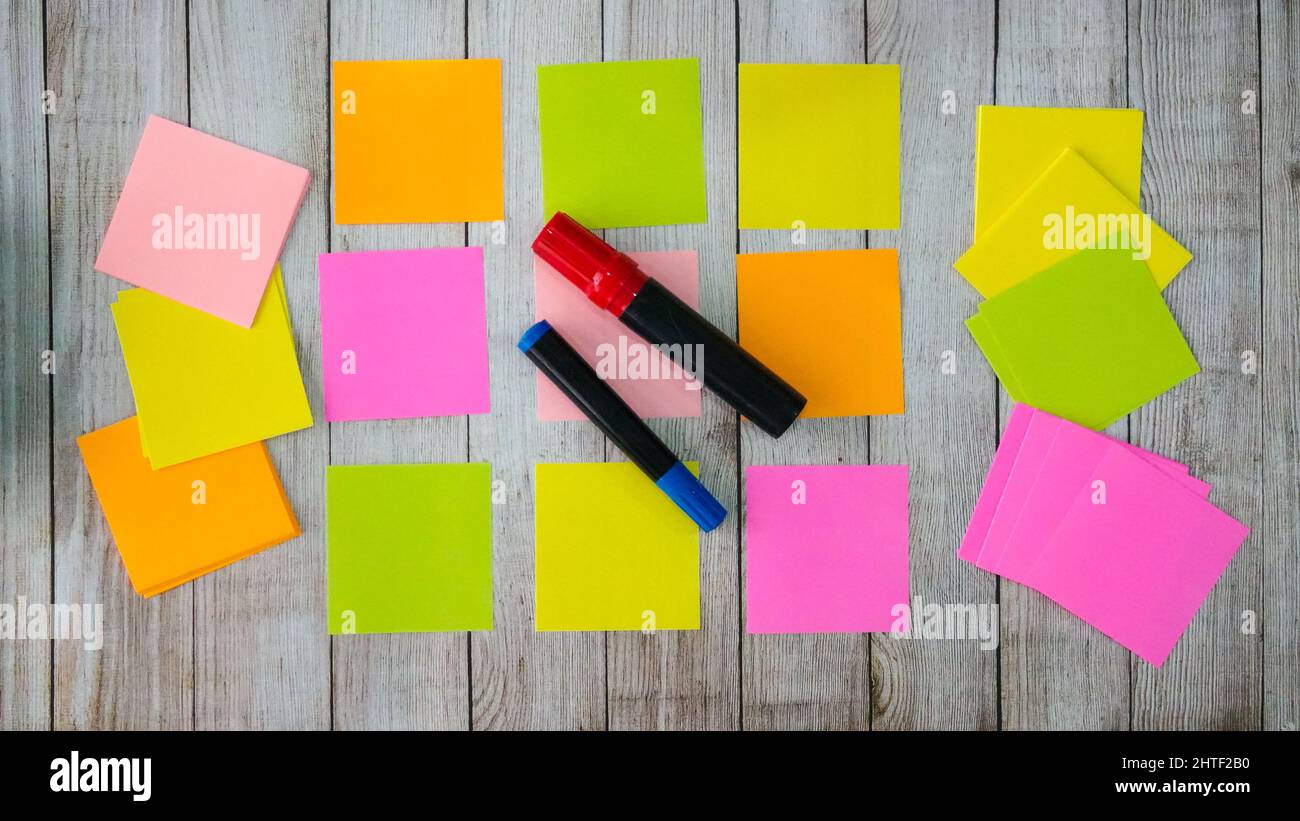 Flat lay with colorful stickers and markers on the wooden background ...