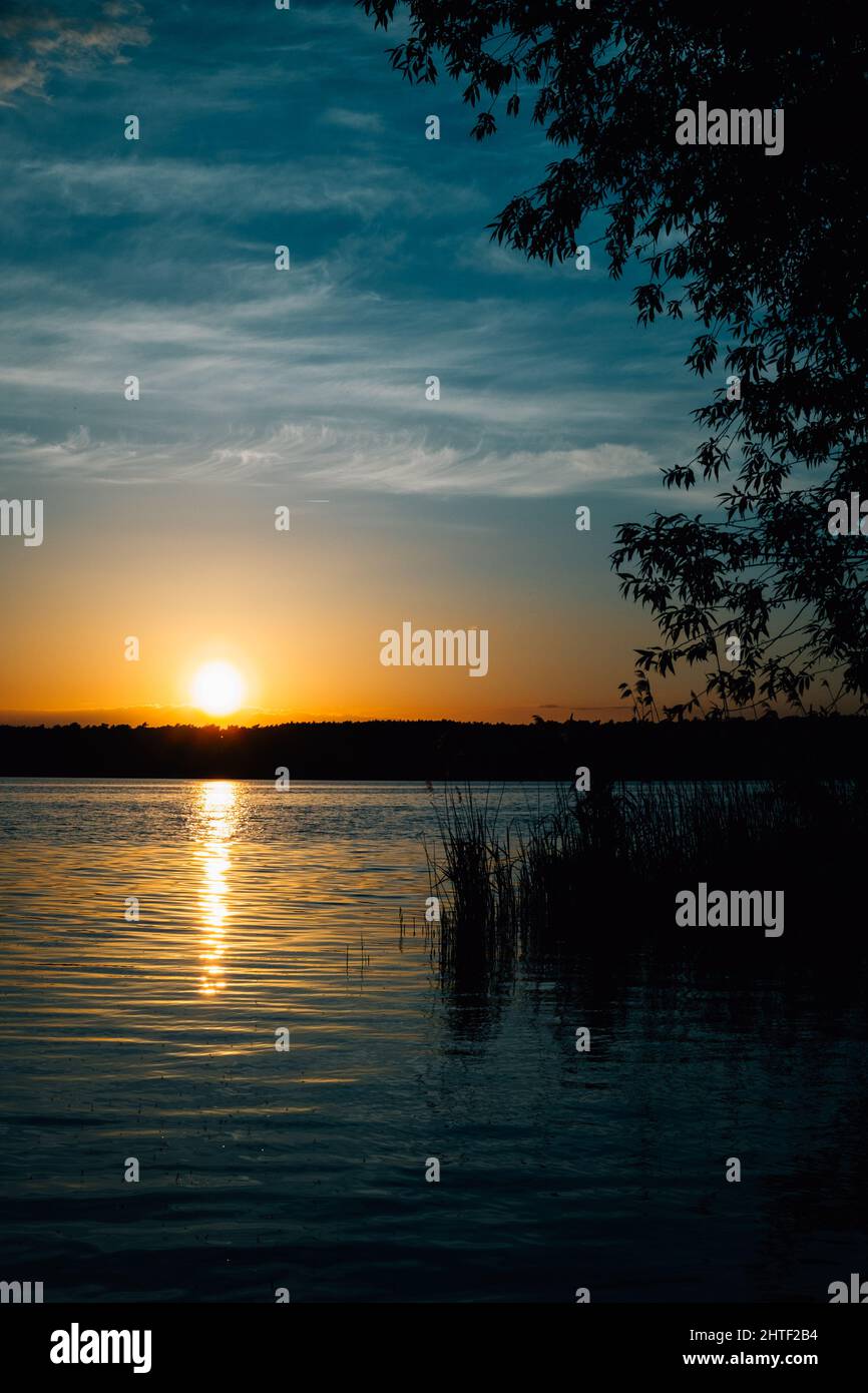 Beautiful scenery with the bright sun setting down over the lake Stock ...