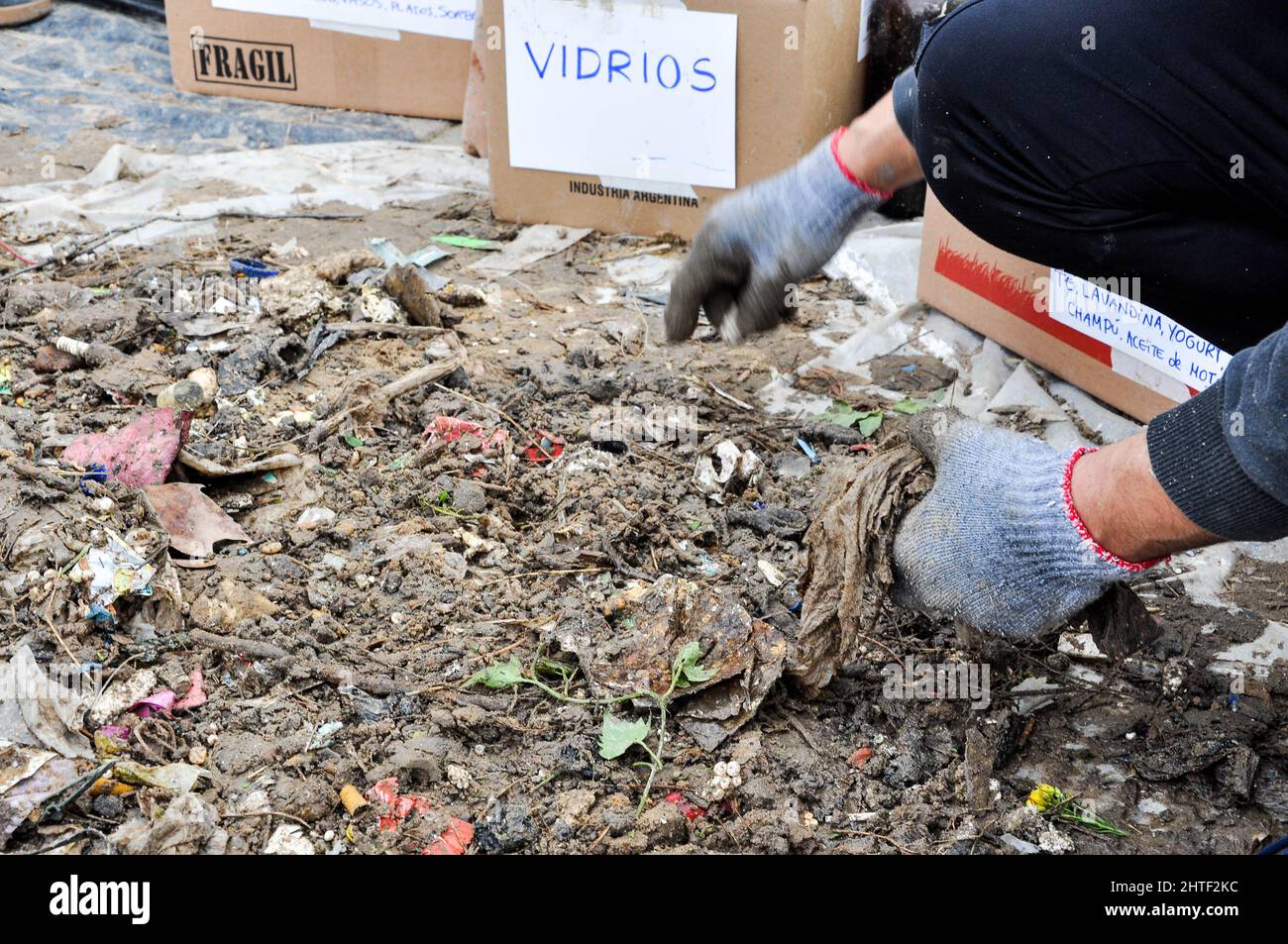 Shot of a man sorting garbage from the Parana river Stock Photo - Alamy