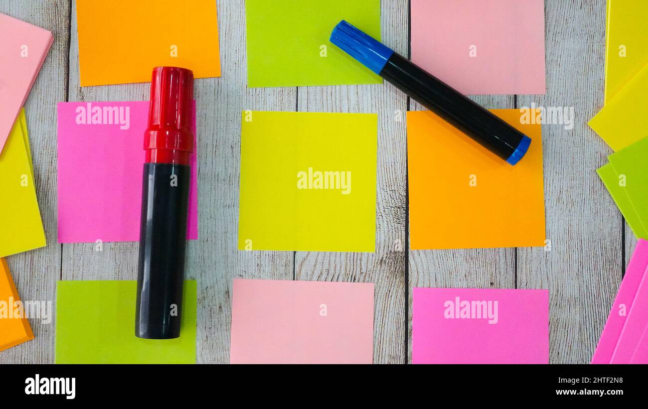 Flat lay with colorful stickers and markers on the wooden background ...