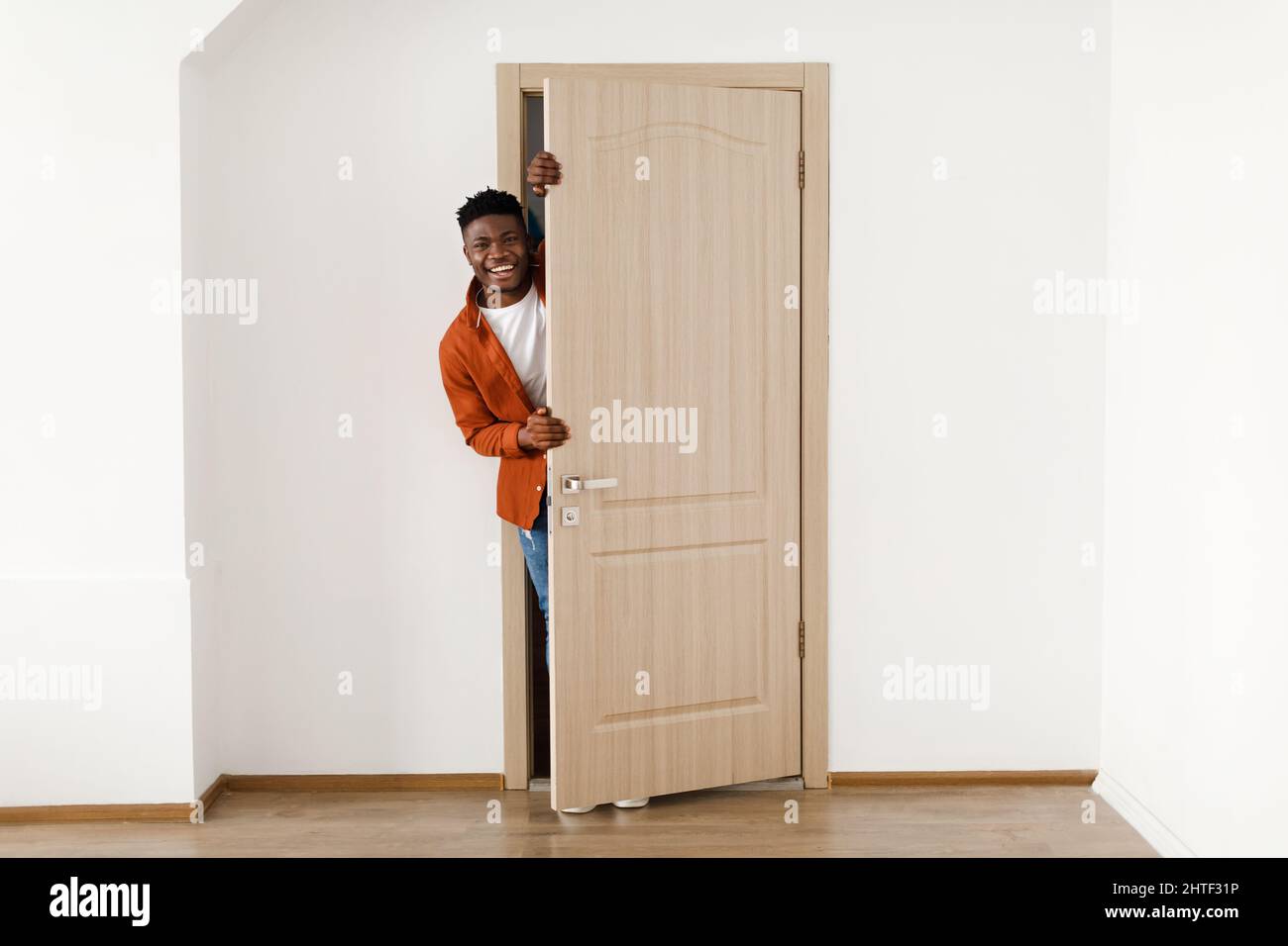 Happy African American Man Smiling Opening The Door At Home Stock Photo ...