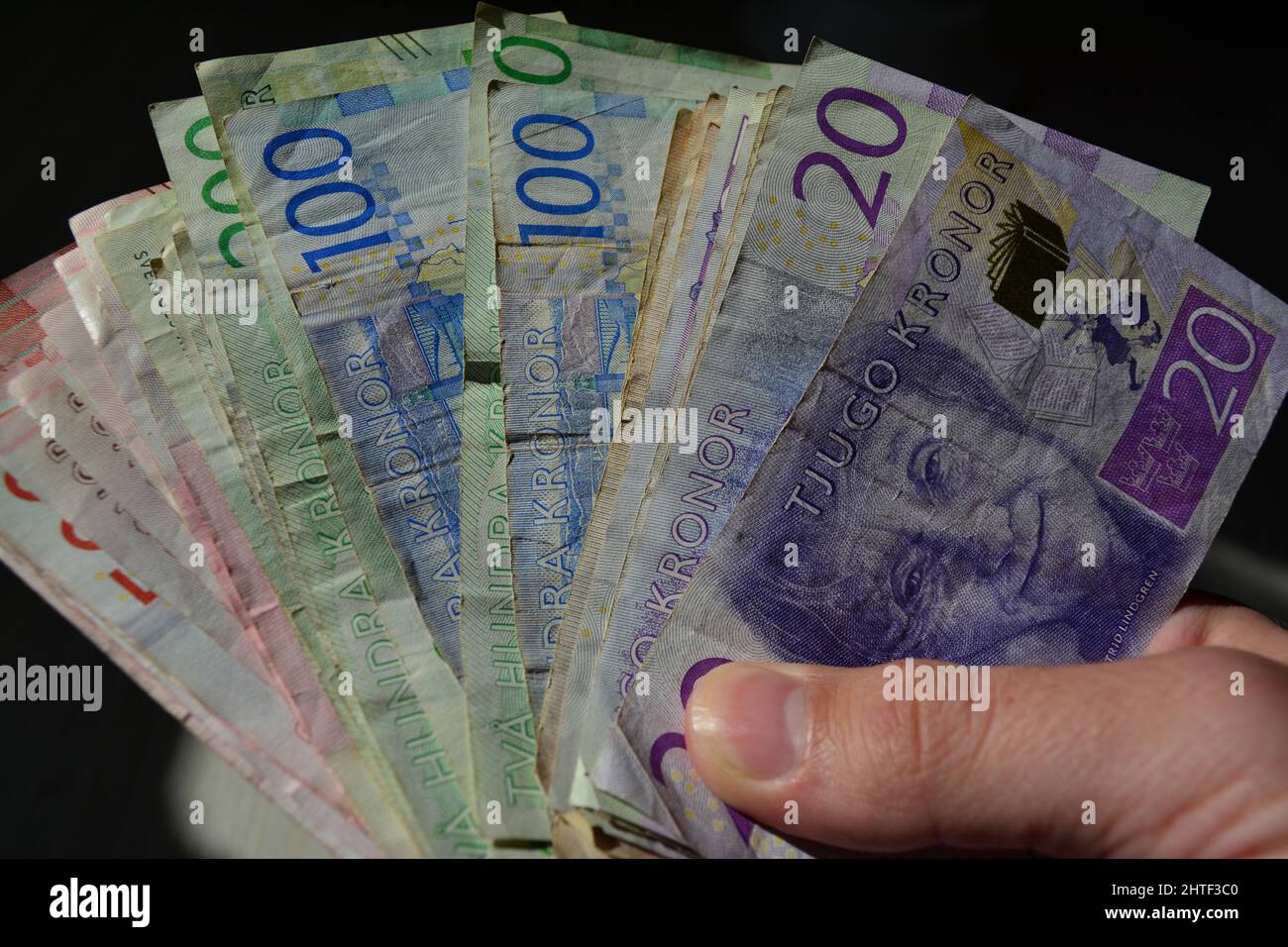 Closeup of a hand holding Swedish currency different banknotes with ...