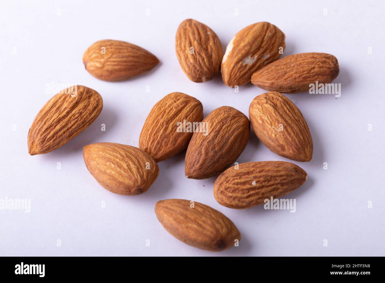 Extreme close-up of almonds on white background Stock Photo - Alamy