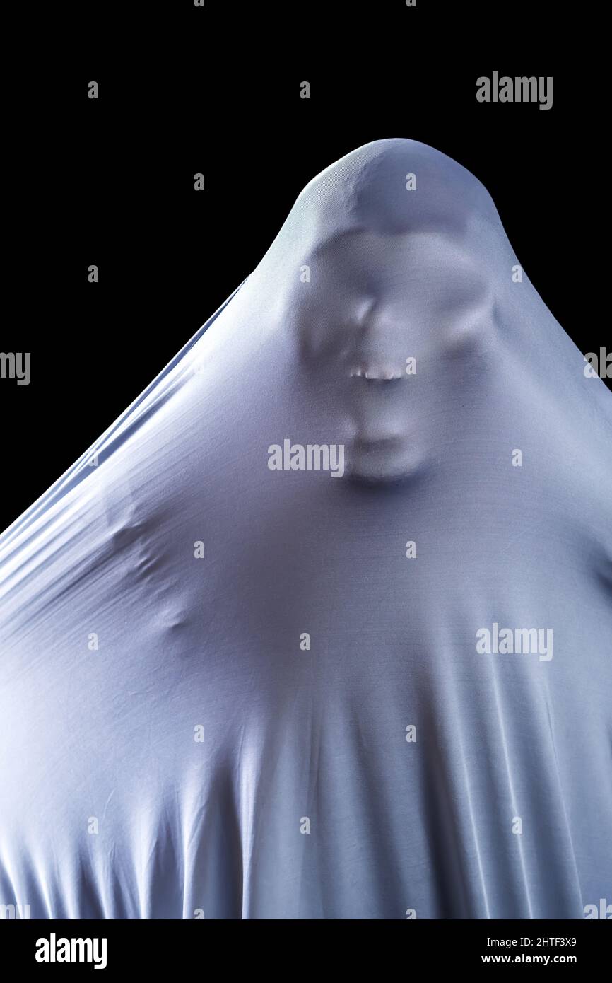 The man is in white clothes and shows a scary looking face isolated on ...