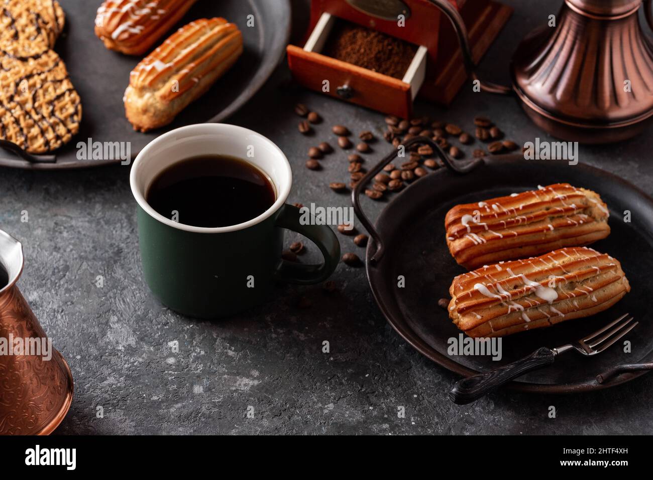 Coffee eclairs on a vintage plate, coffee, coffee grinder Stock Photo ...
