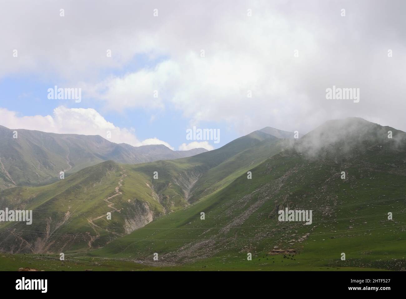 Cloudy sky over the green mountains Stock Photo - Alamy