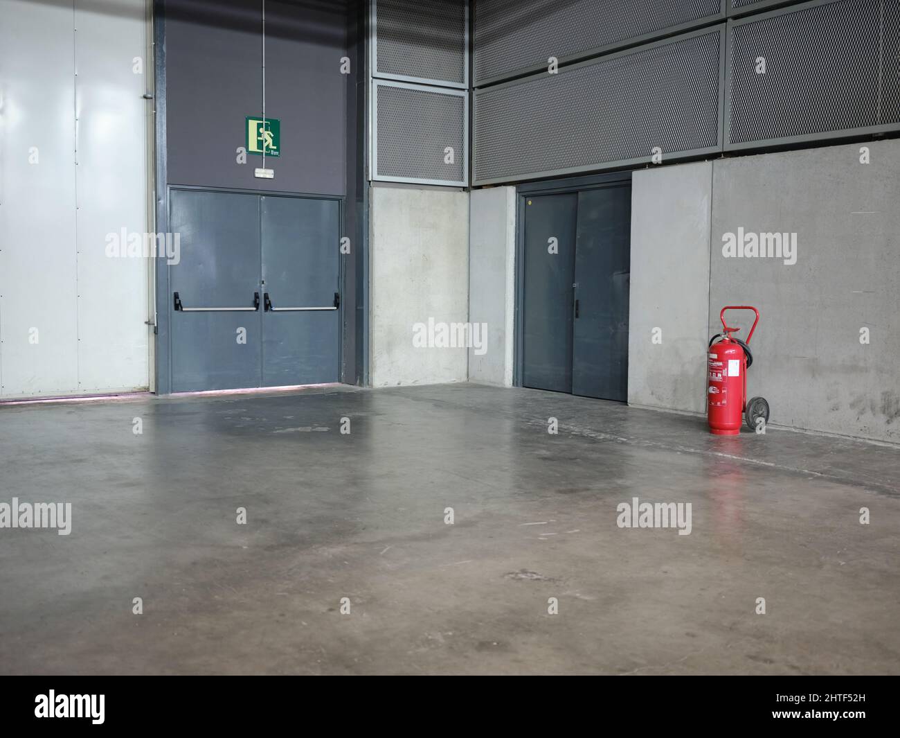 Emergency exit doors of an industrial area with a fire extinguisher ...