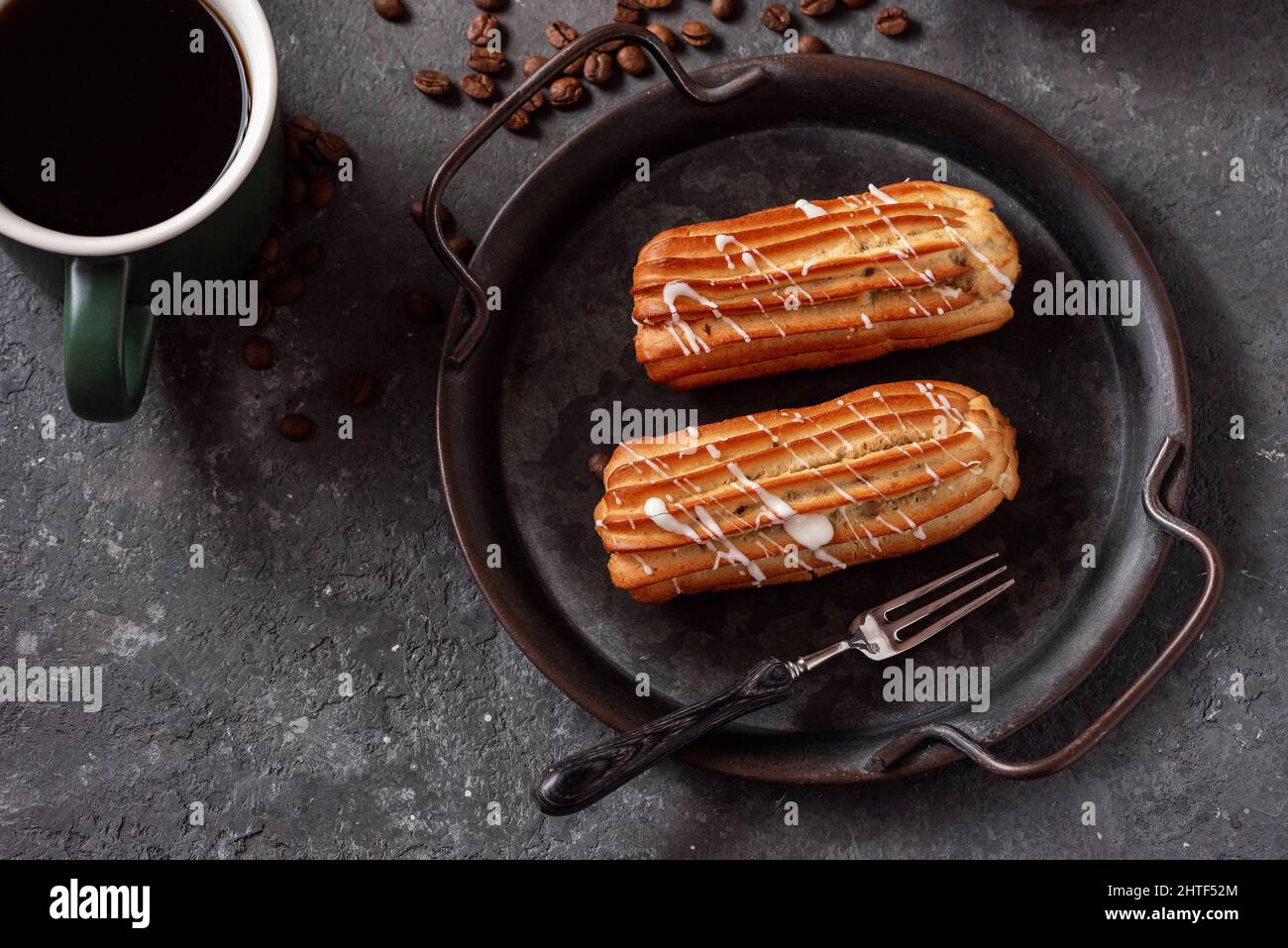 Coffee eclairs on a vintage plate, coffee, coffee grinder Stock Photo ...