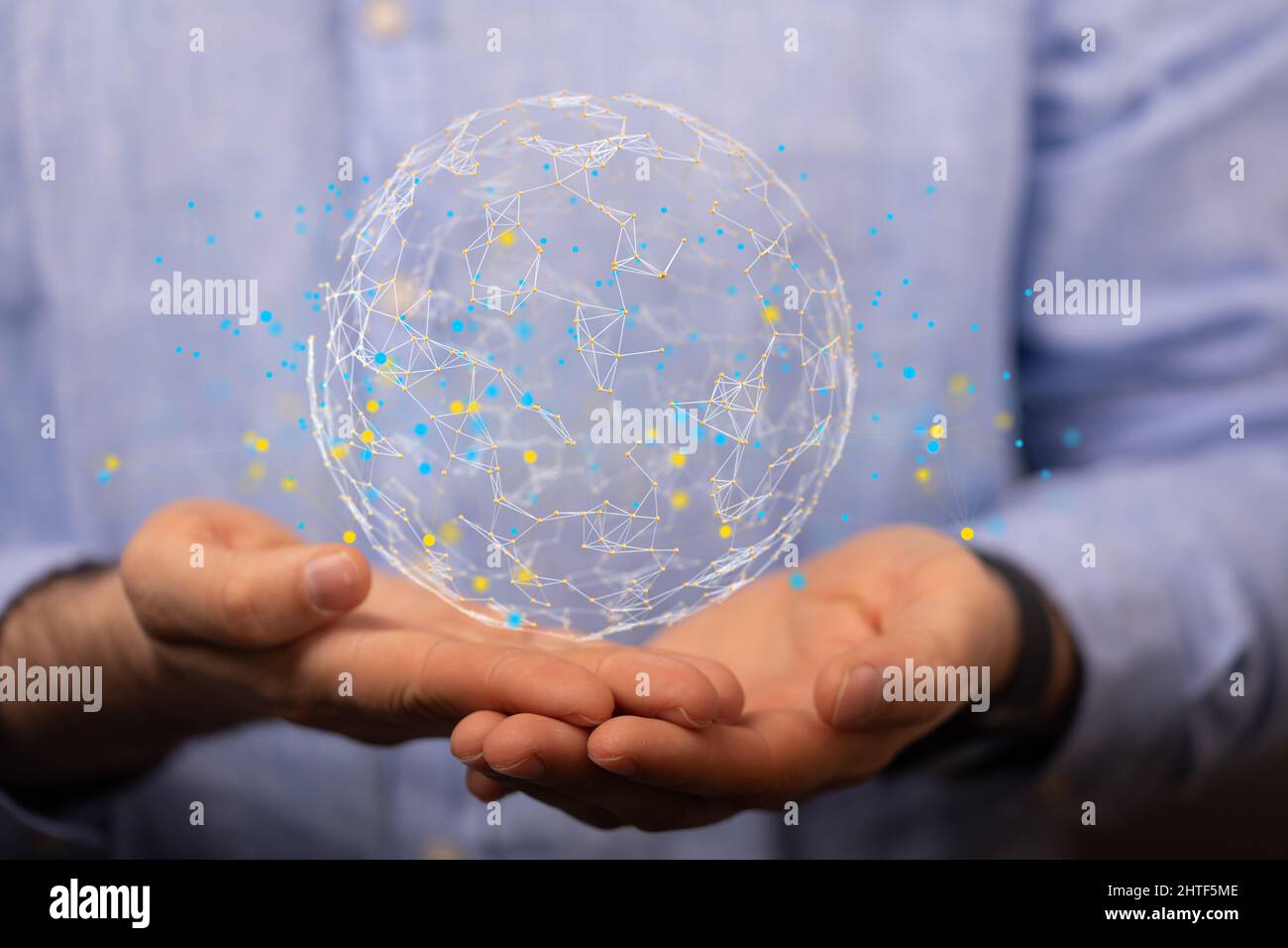 3D spherical icon about the internet above the hands of a man in the ...