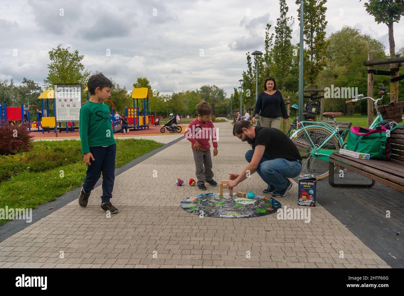 Man and kids playing with an Angry Birds outdoor throw game on a ...