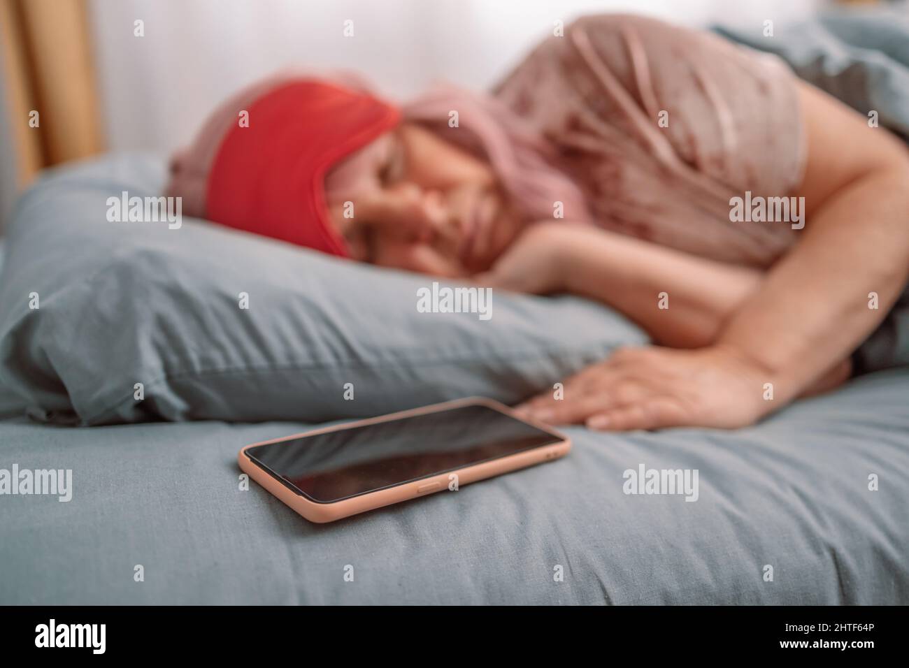 Sweet Dreams. Beautiful 50s woman in eye mask sleeping in bed early in ...