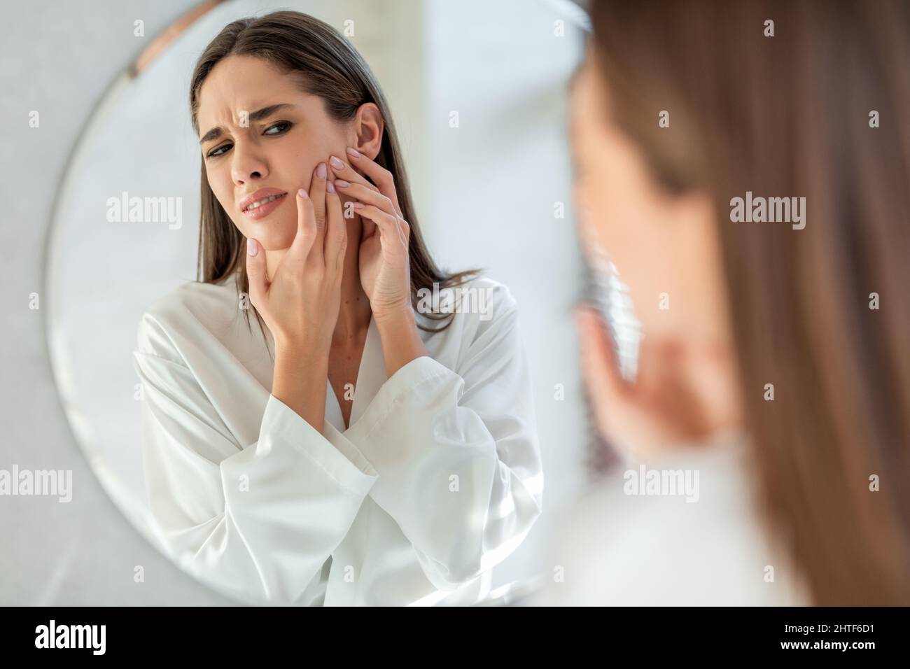 Frustrated Young Woman With Problem Skin Popping Pimple On Cheek Near ...