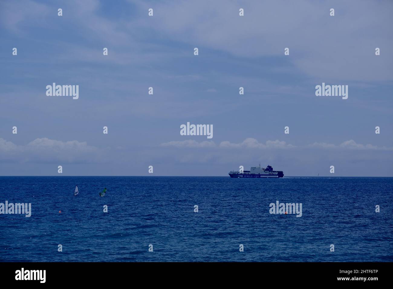 Ship passing on the horizon of the blue calm sea Stock Photo - Alamy
