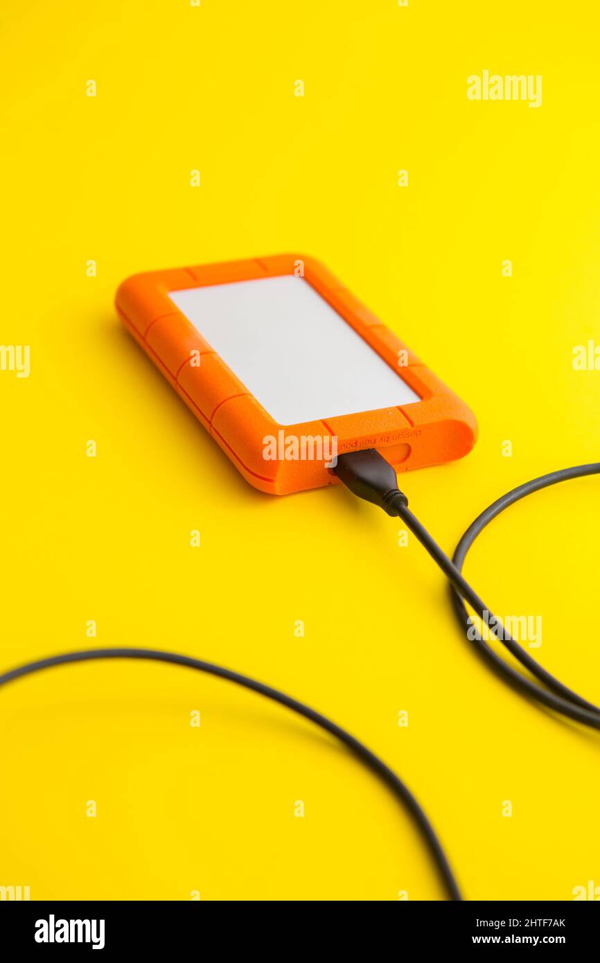 external hard drive on a yellow background Stock Photo - Alamy