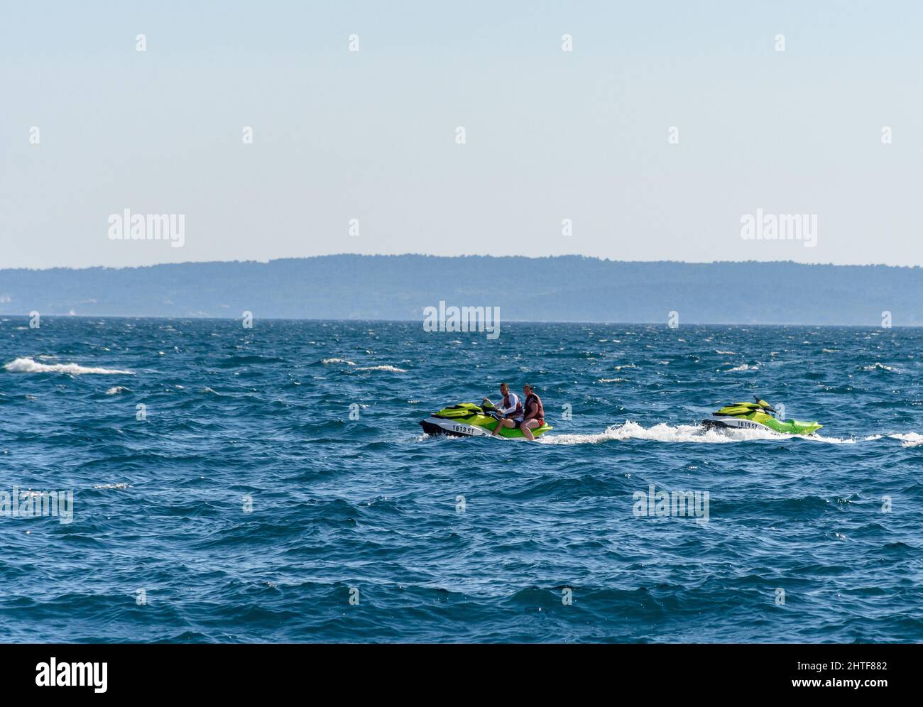 Group of people having fun riding a jet ski in the sea Stock Photo - Alamy