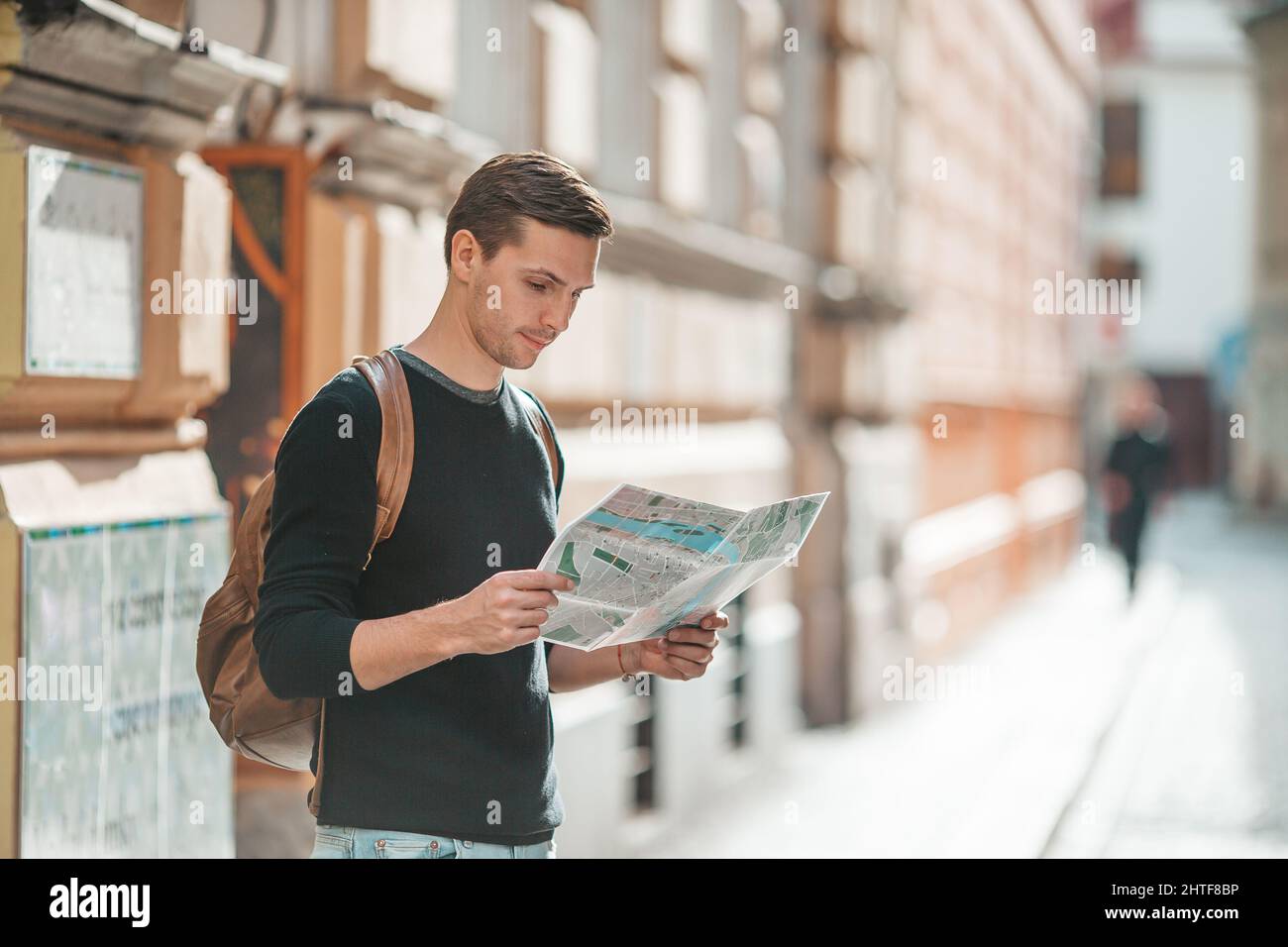 Young man searching for place of destination. Caucasian tourist looking ...
