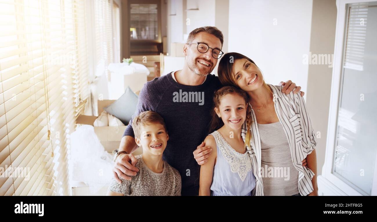 Welcome to our new home. Portrait of a happy family together in their ...