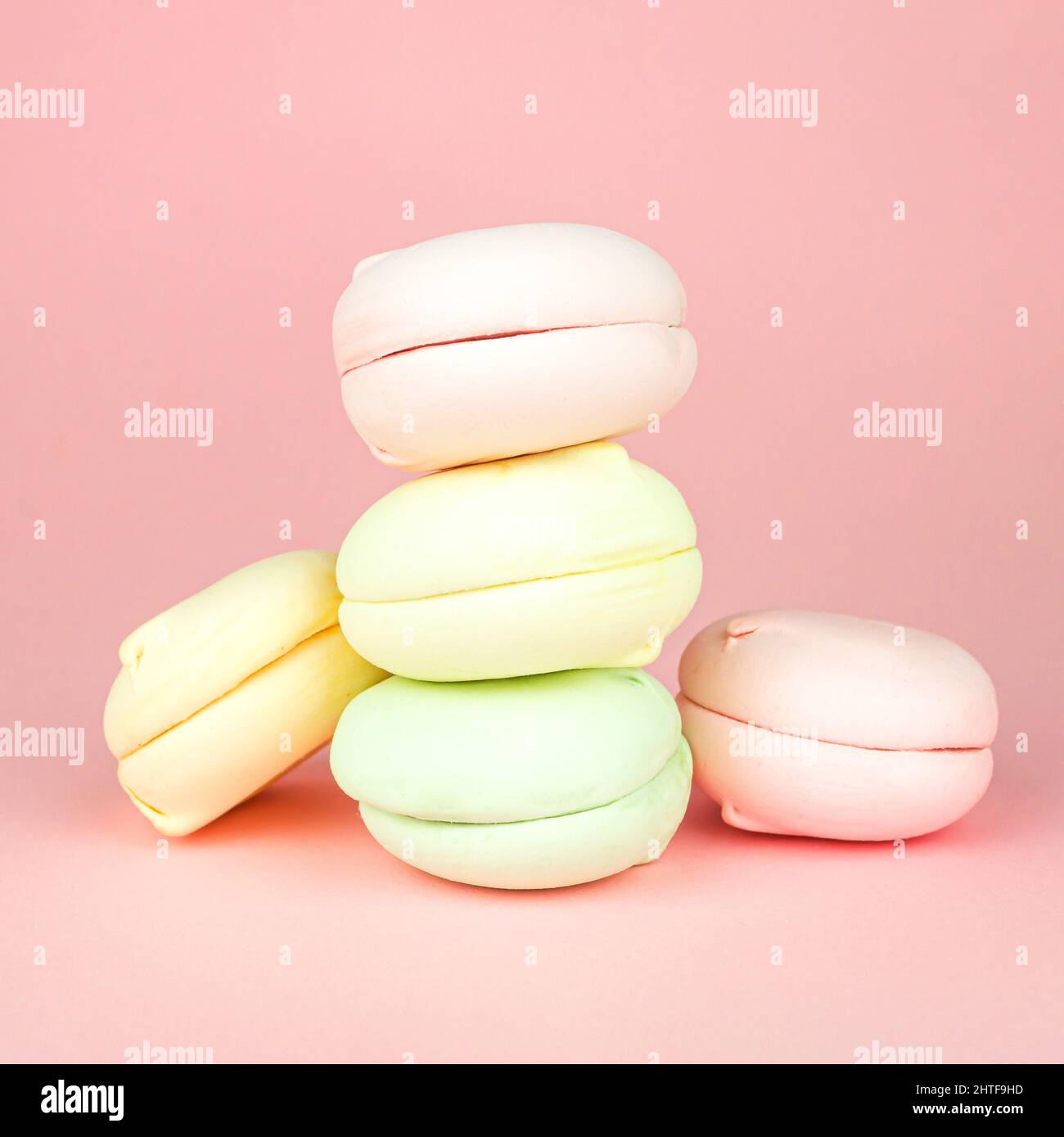 Colorful marshmallows looks like macaroons on pastel pink background ...