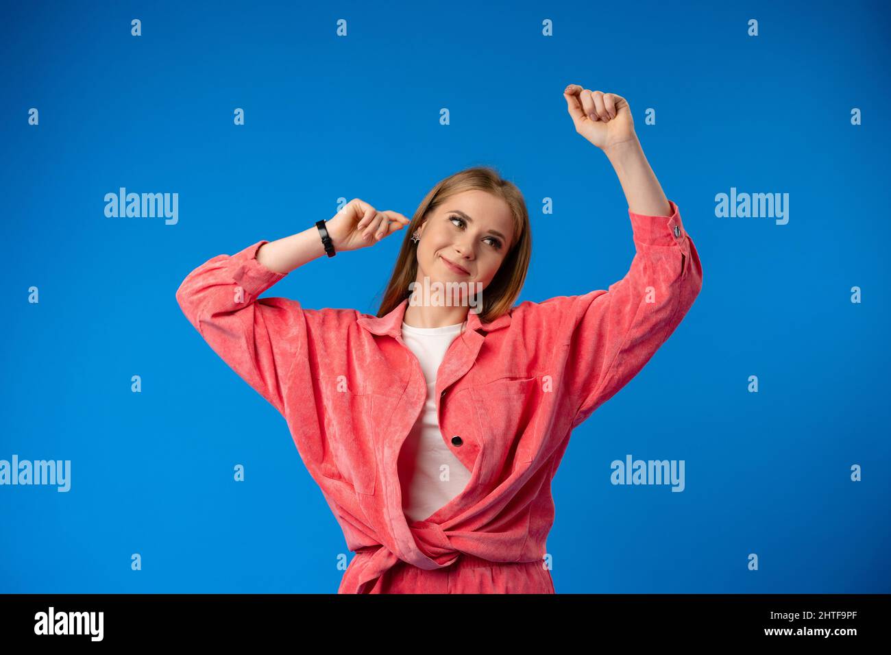 Excited thrilled woman portrait on blue studio background Stock Photo ...