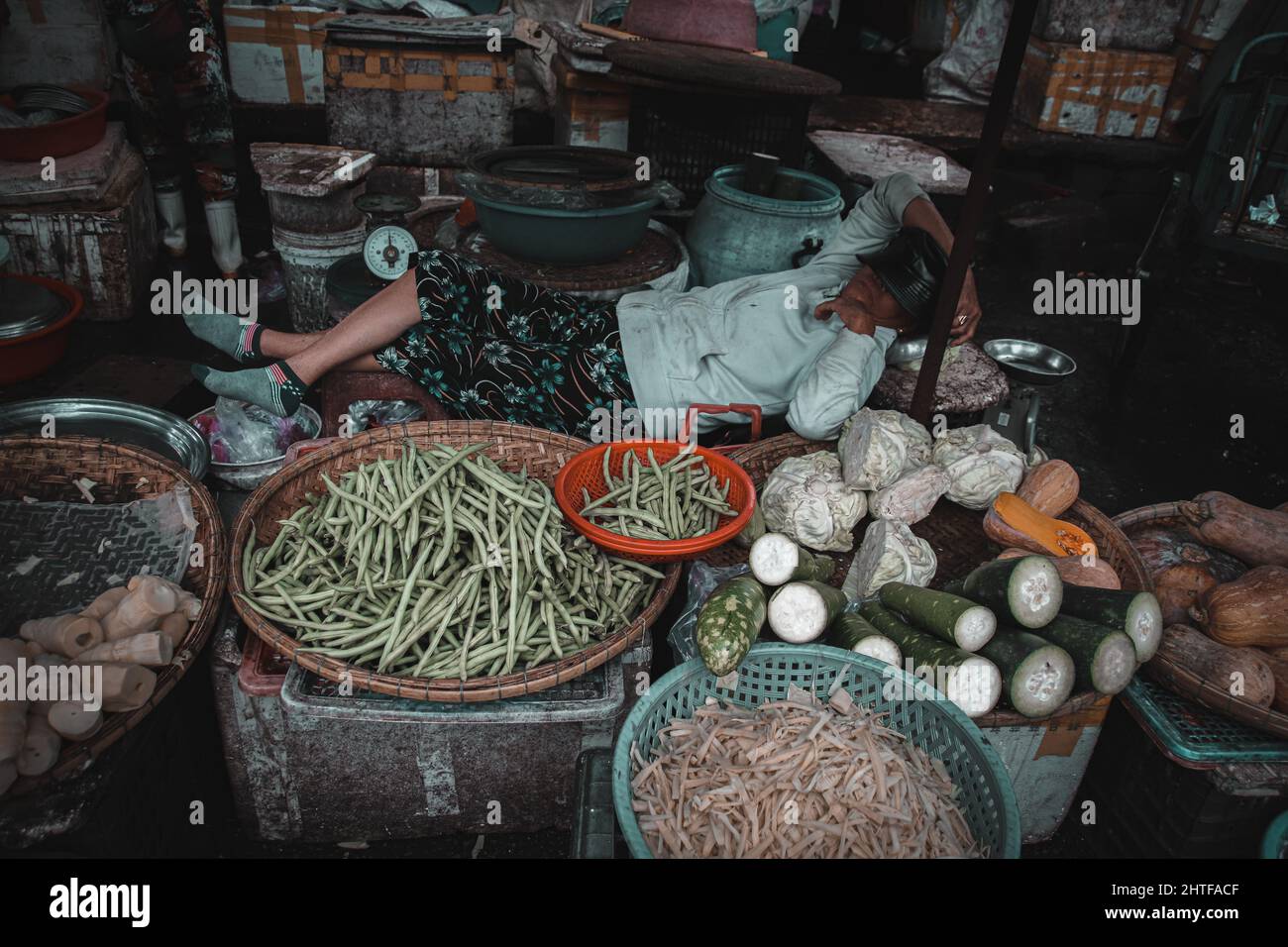 Khmer woman sleeping in her vegetable shop at the local market of ...
