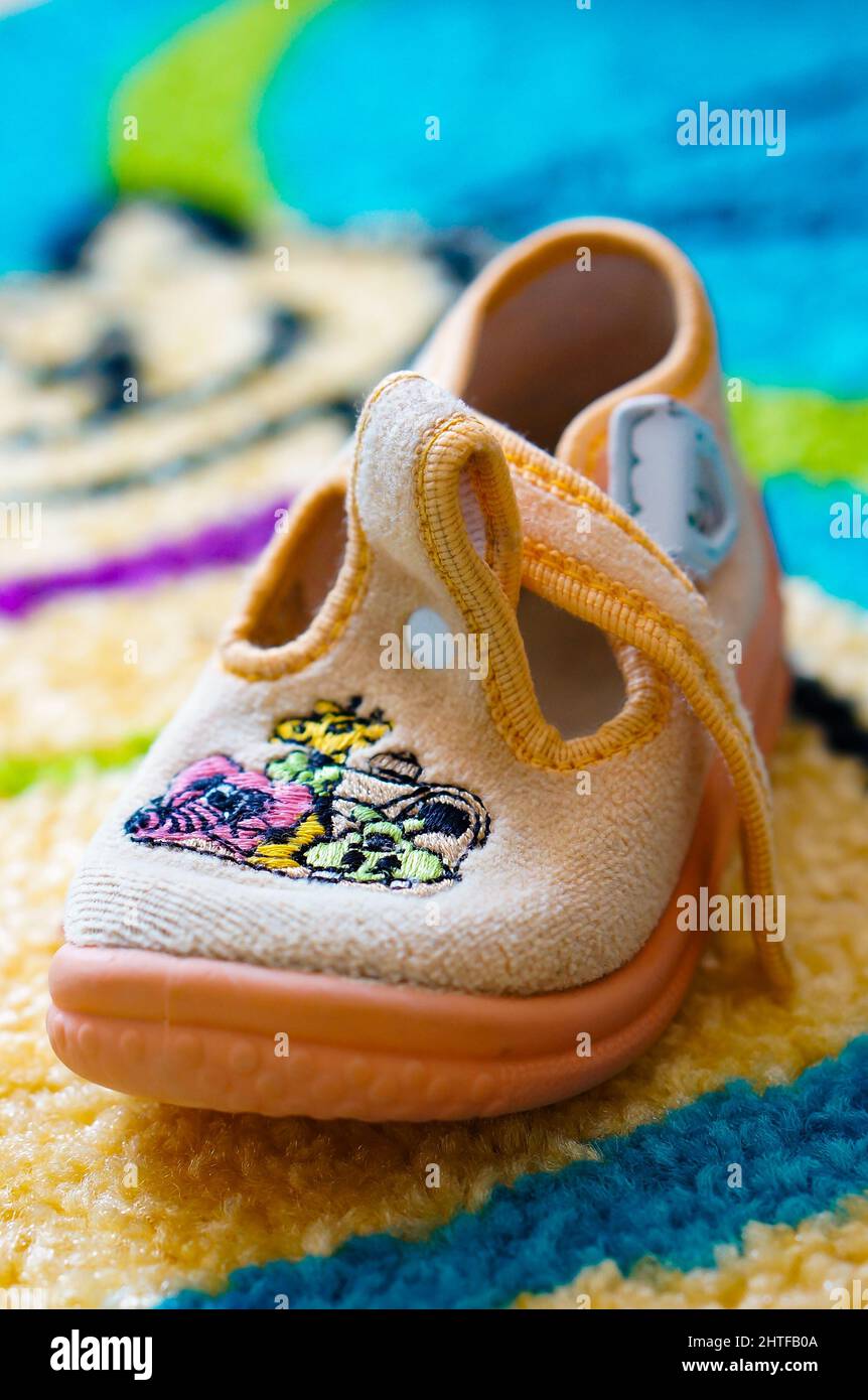 Cute small baby shoe on the floor Stock Photo - Alamy