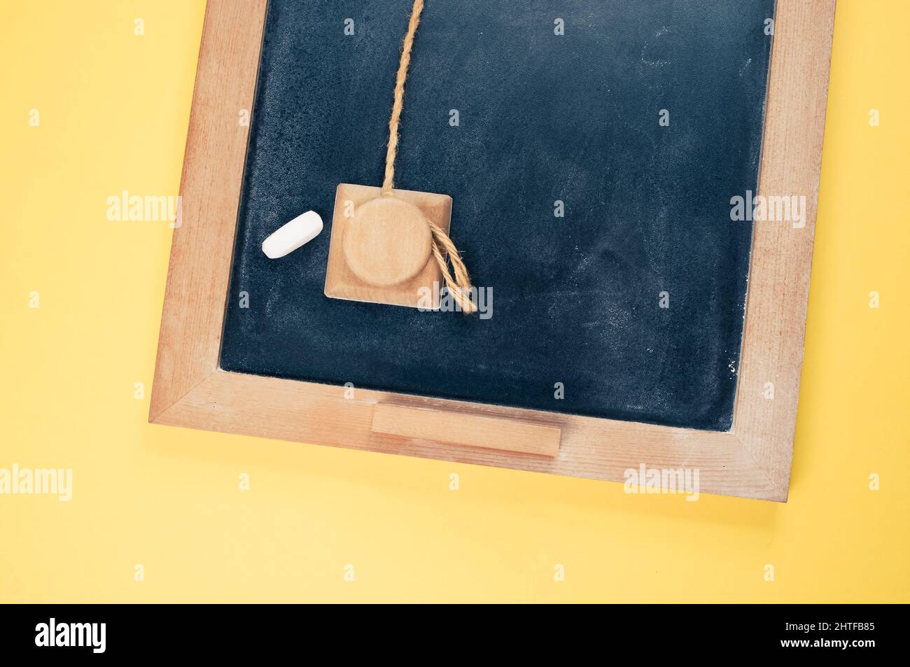 Top view of a small wall chalkboard for schedules on orange background ...