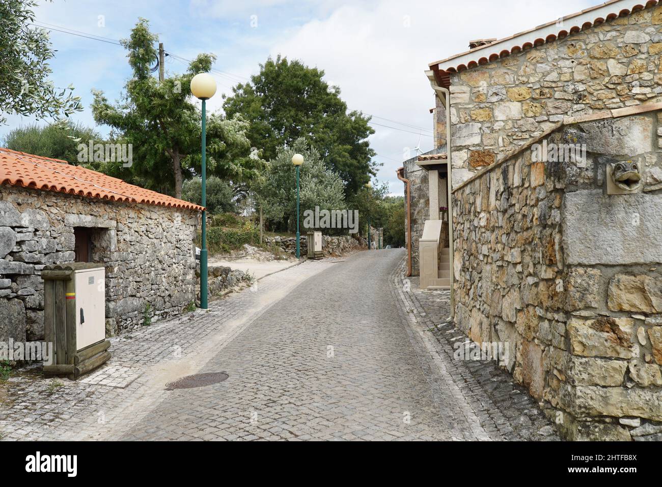 Beautiful shot of a small path of a village with houses on both of its ...