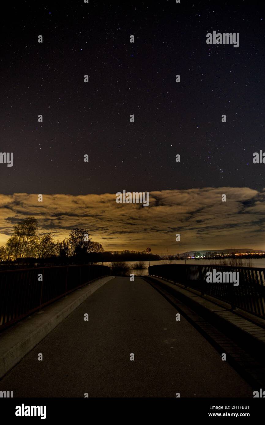 Starry sky over pedestrian bridge Stock Photo - Alamy