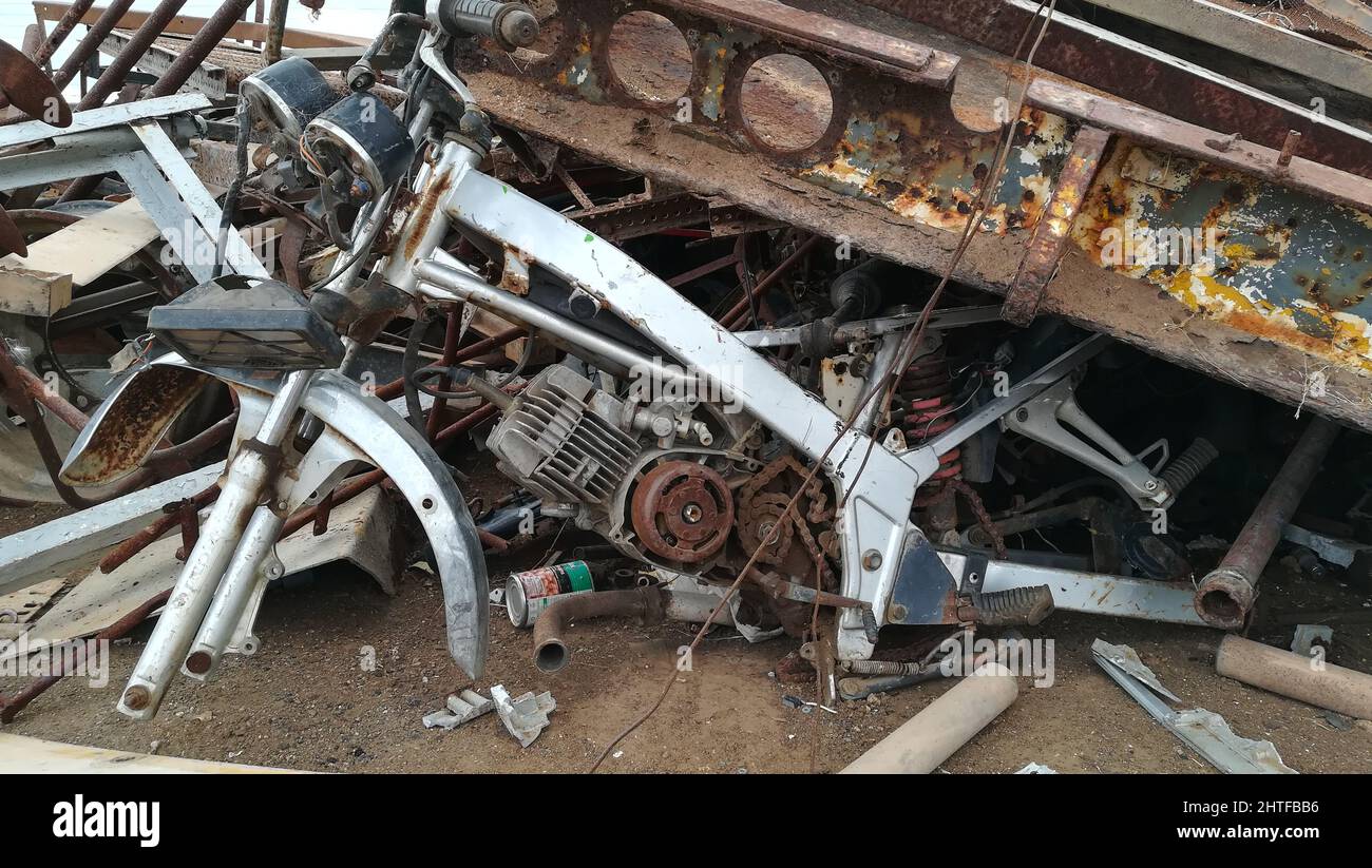 Closeup of different broken parts of a vehicle dumped together in a ...