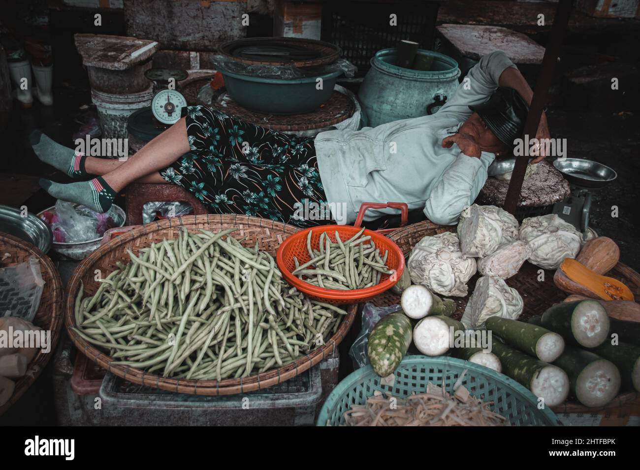 Khmer woman sleeping in her vegetable shop at the local market of ...