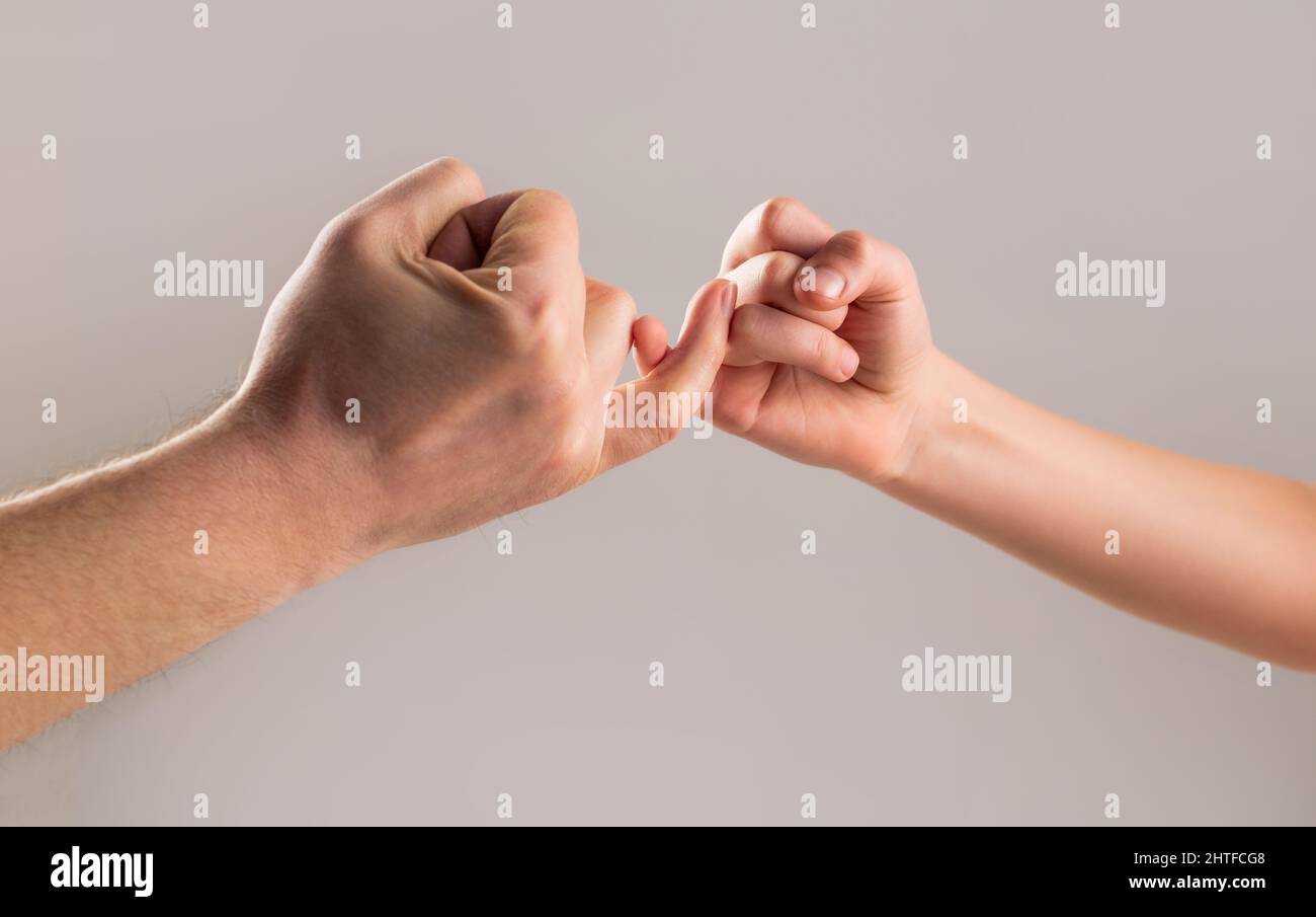 Child hook little finger together. Little finger of the two hands hold ...