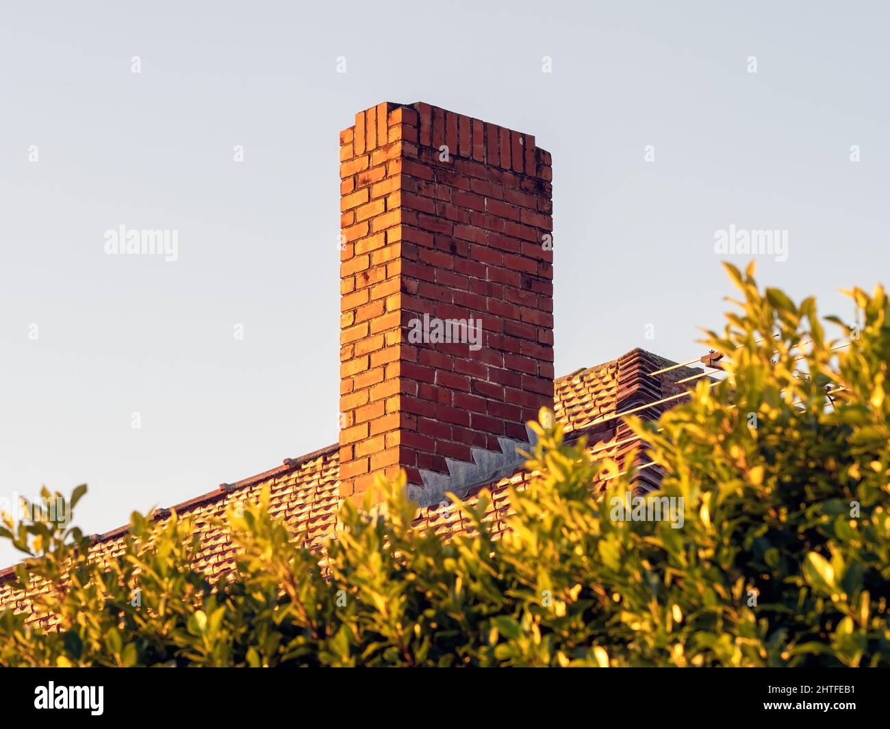 red tile house roof with red brick chimney Stock Photo - Alamy