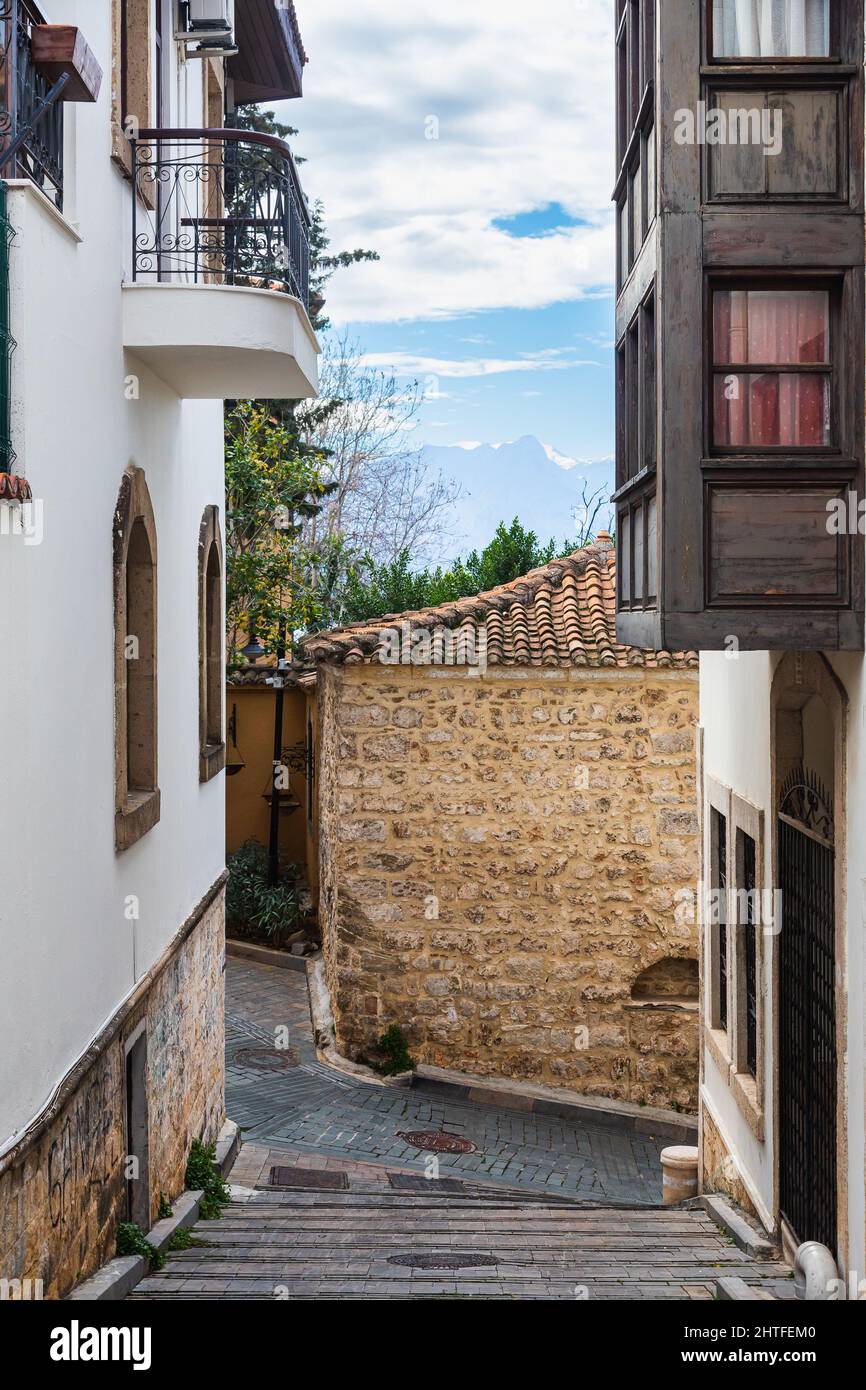narrow pedestrian street with low buildings in the style of European ...