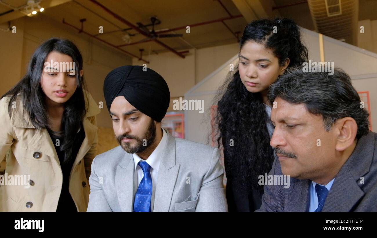 Group of Indian workers brainstorming during a business meeting in ...