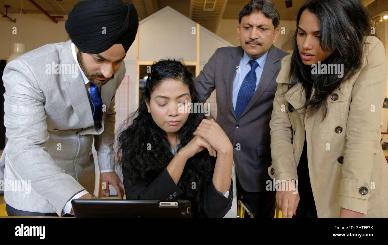 Corporate team of South Asians from India working together looking at a tablet Stock Photo - Alamy