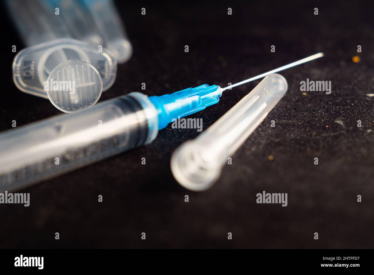 Close-up photo of an open syringe on a black surface Stock Photo - Alamy