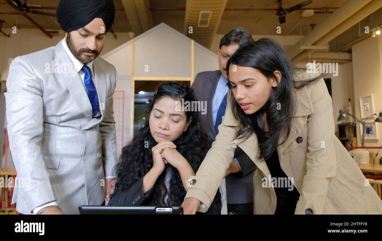 Group of Indian workers brainstorming during a business meeting in ...