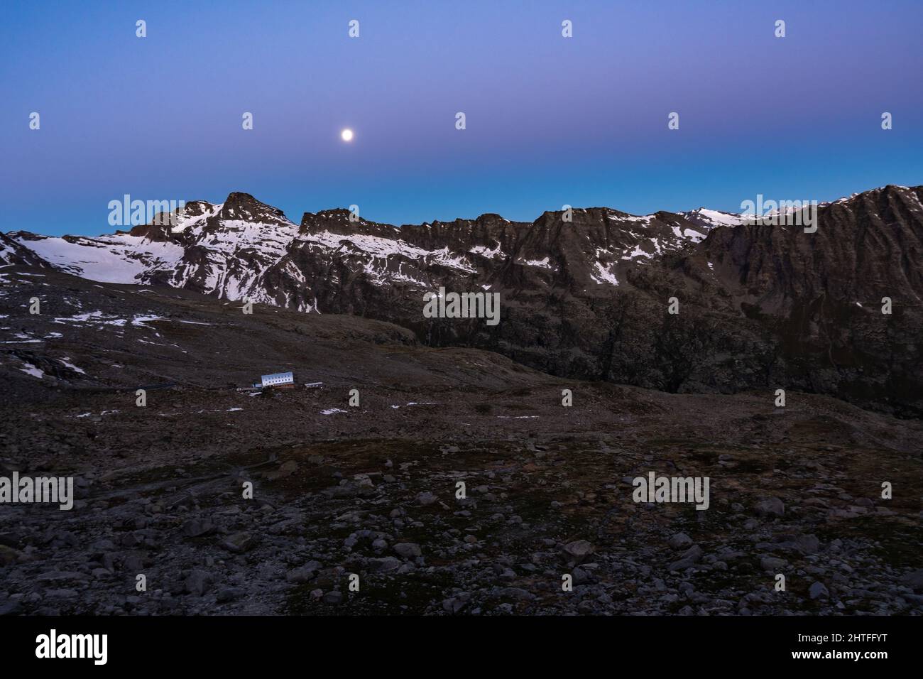 Nighttime with shining moon over a valley in the alps Stock Photo - Alamy