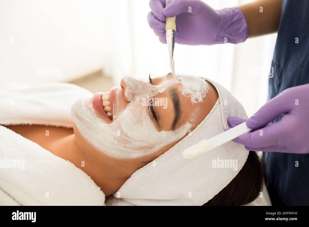 Spanish female taking spa facial treatment Stock Photo - Alamy