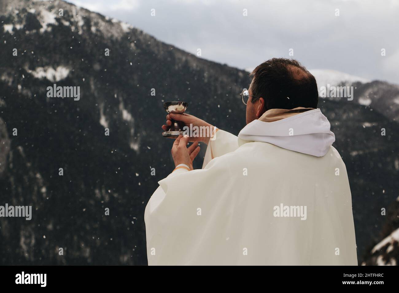 Religious man performing a ritual in the snowy mountains Stock Photo ...