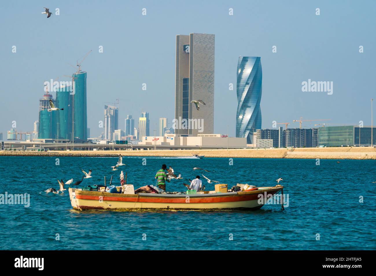 Two fishermen on a boat near the Coastal area of Muhraq, Manama ...