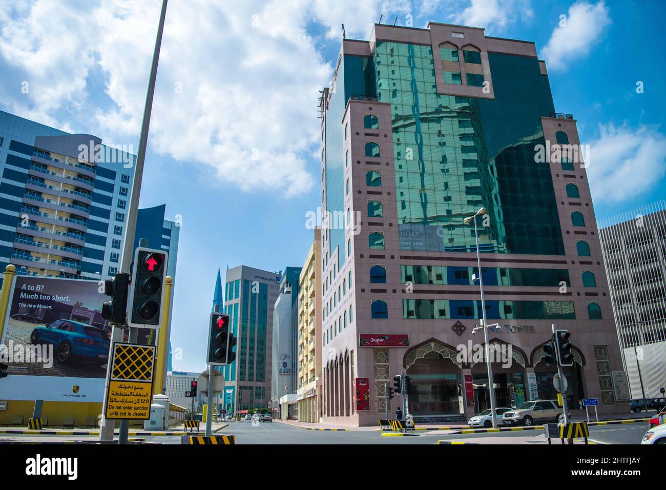 Low angle shot of downtown buildings and streets in the city of Manama ...